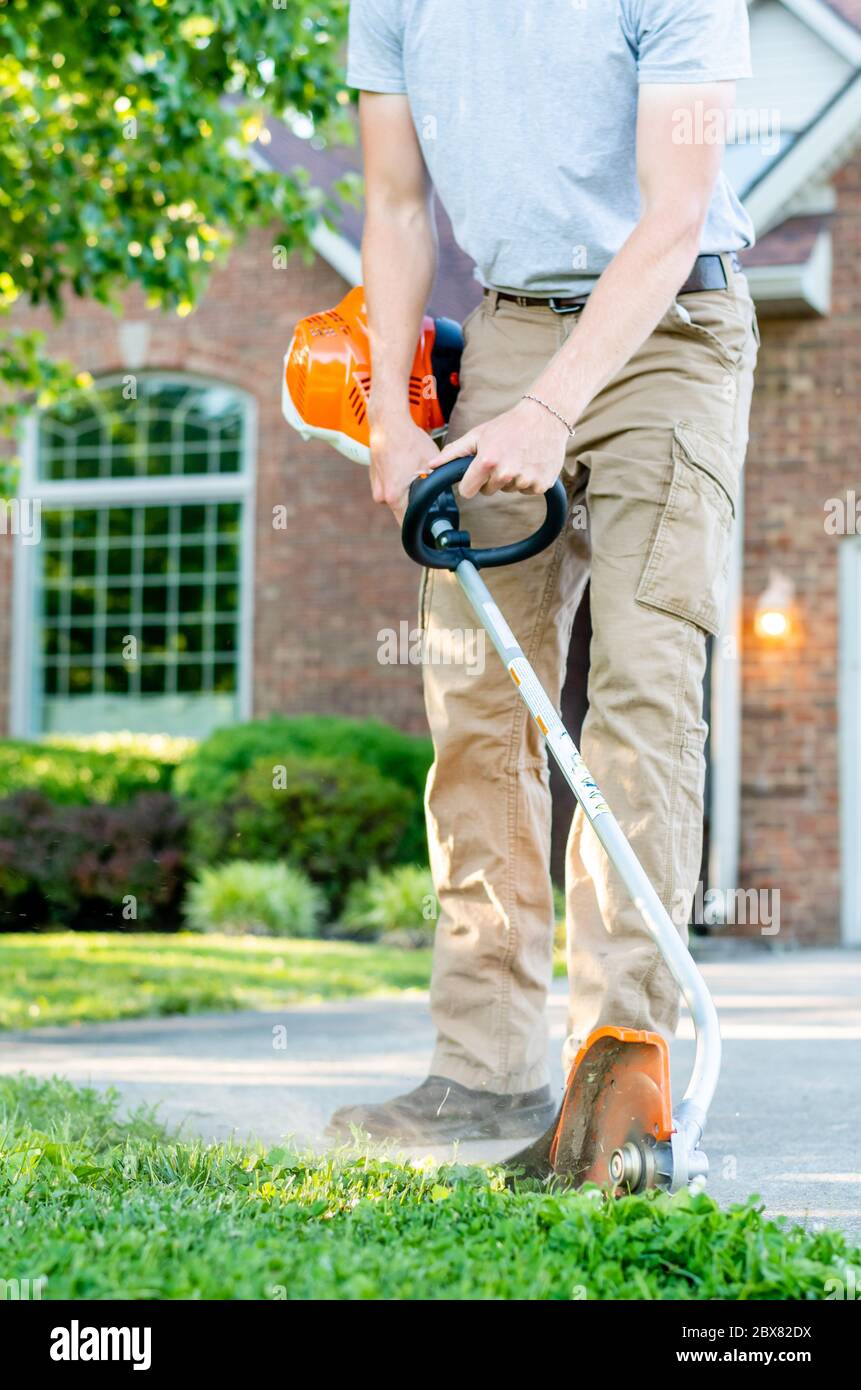 Man using string trimmer cut hi-res stock photography and images - Alamy