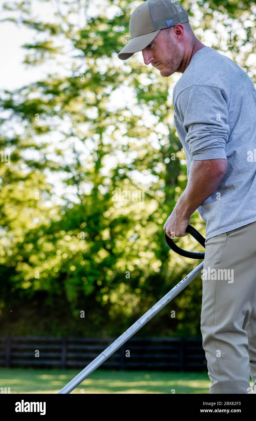 Caucasian man using weed eater/ line trimmer in Kentucky Stock Photo ...