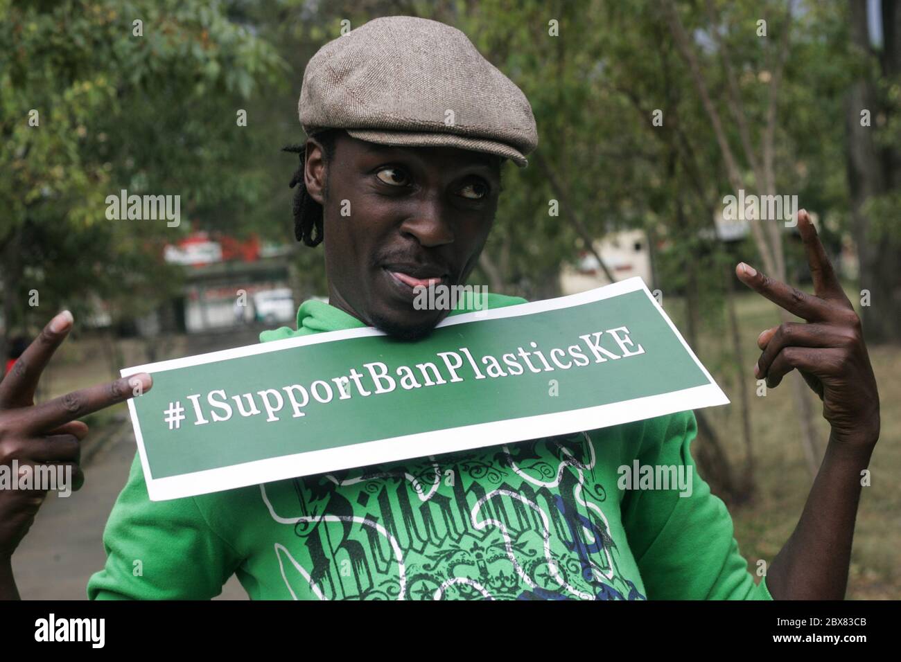 A man makes gestures while holding a placard saying 'I Support Ban ...