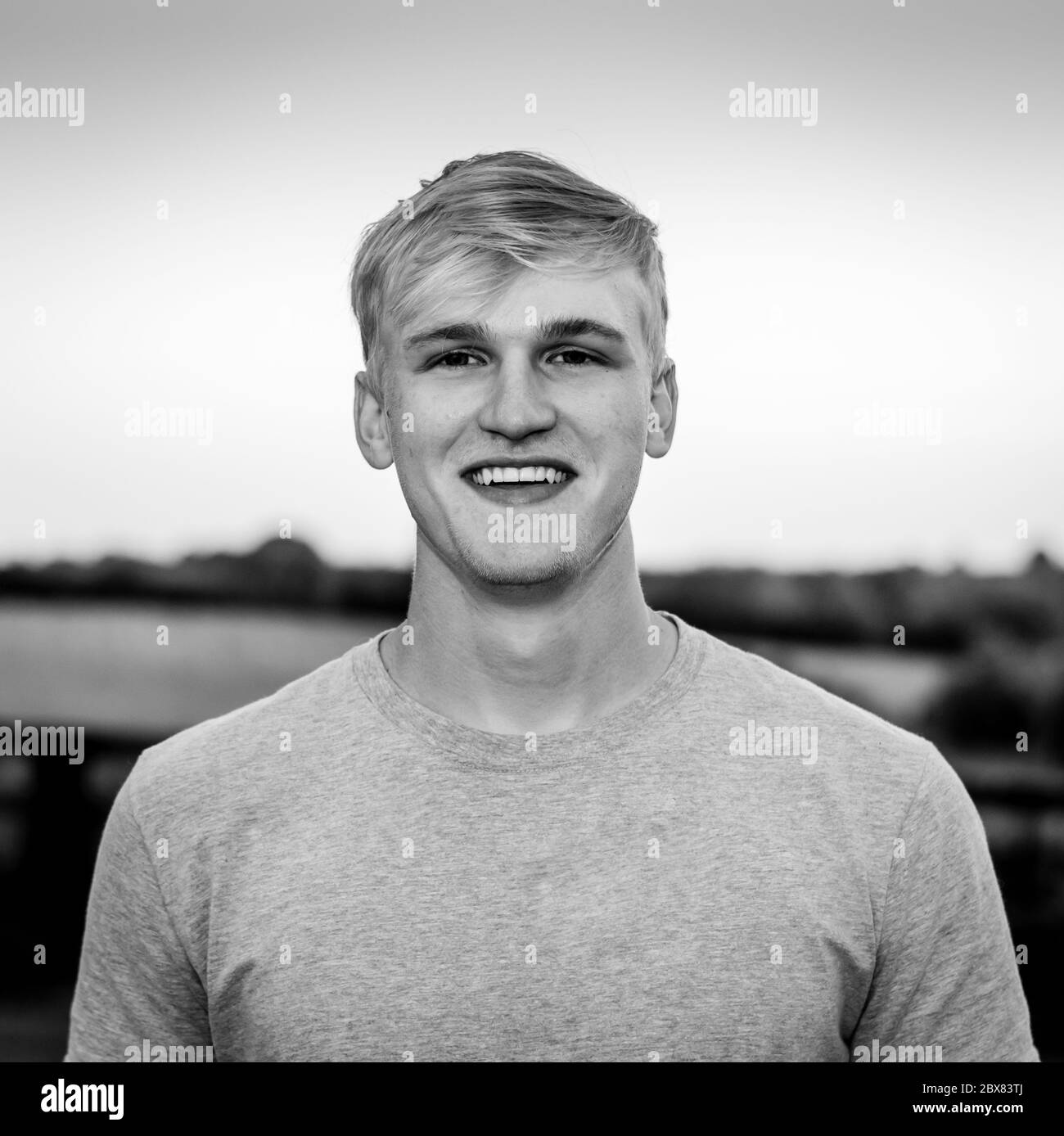 Black and white portrait of young caucasian man smiling Stock Photo - Alamy
