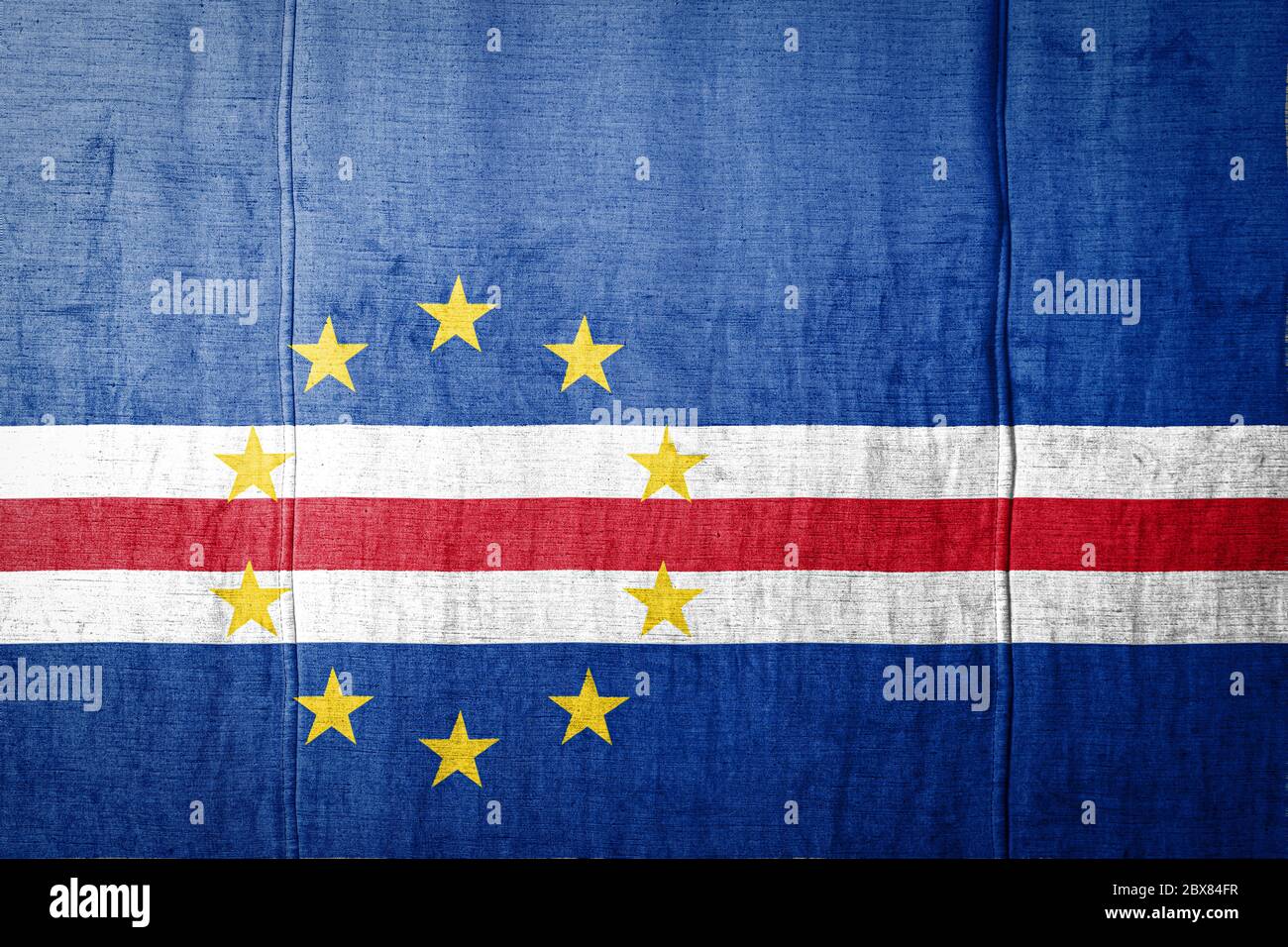 National flag of Cape Verde depicting in paint colors on old textile ...