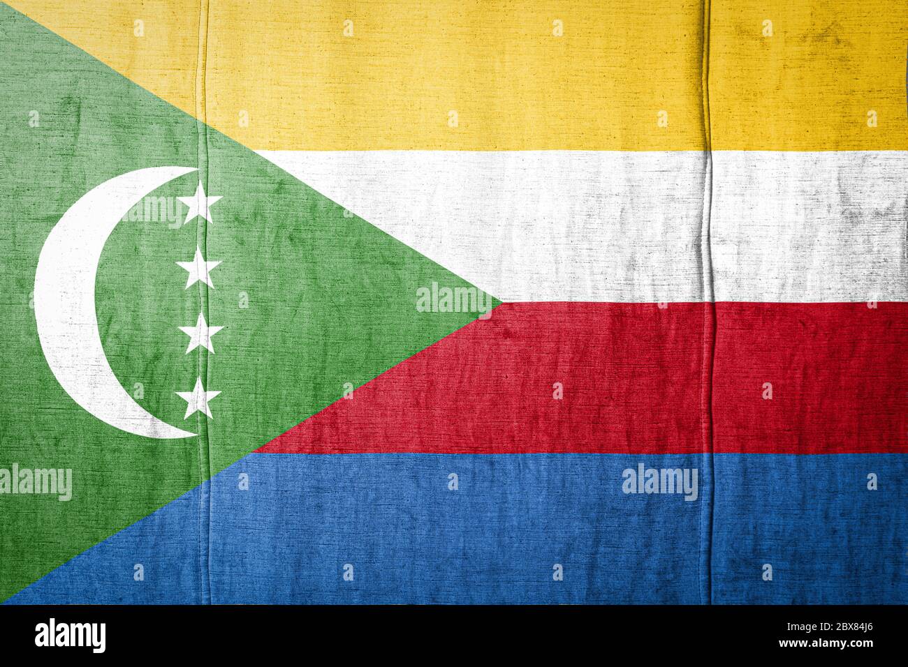 National flag of Comoros depicting in paint colors on old textile. Flag ...