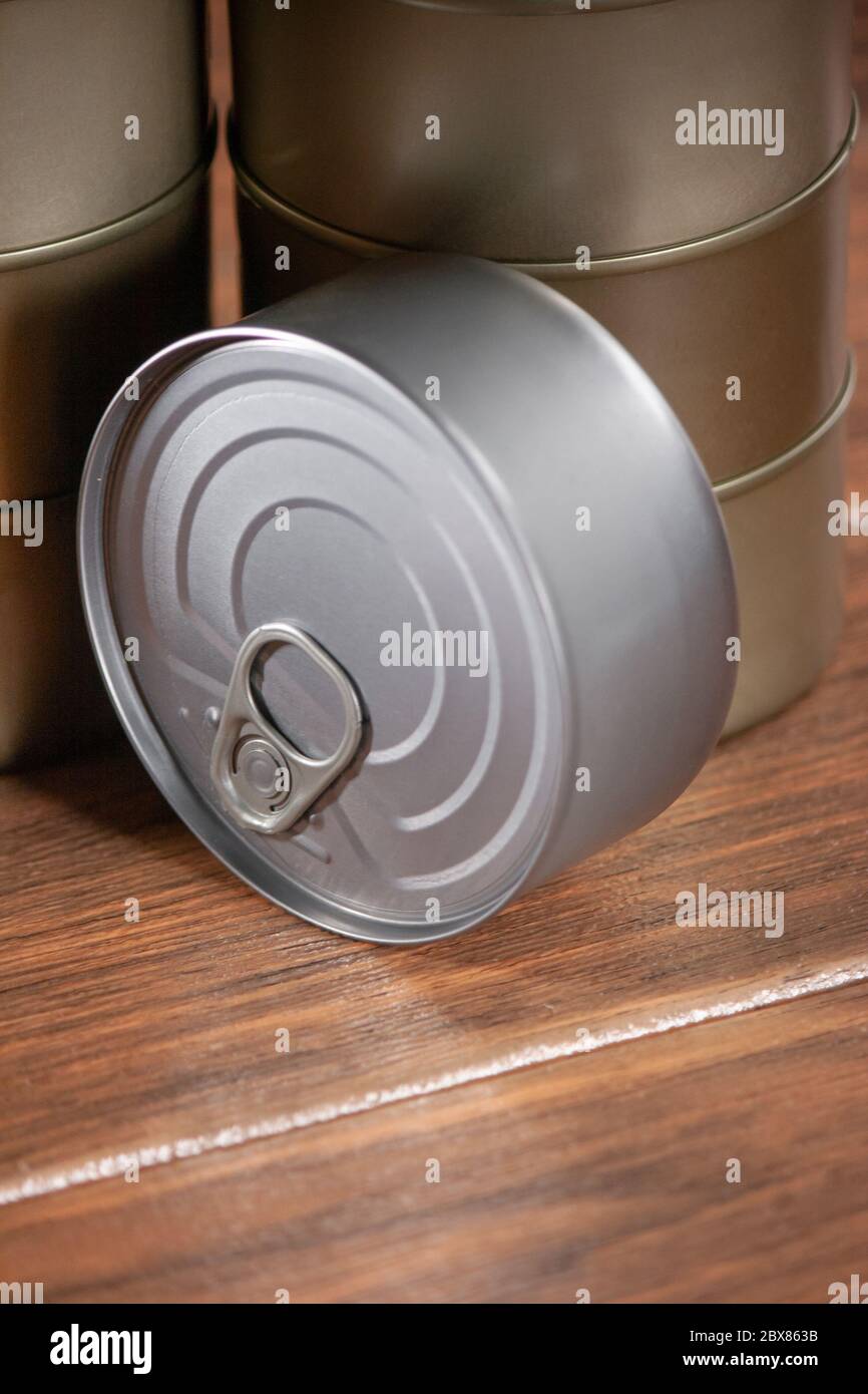 tin of silver tuna on the side with close view on brown wood and ...