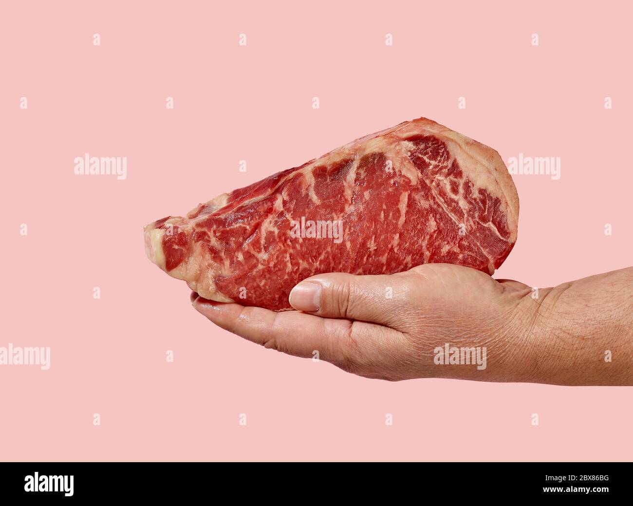 Hand holding piece raw meat hi-res stock photography and images - Alamy