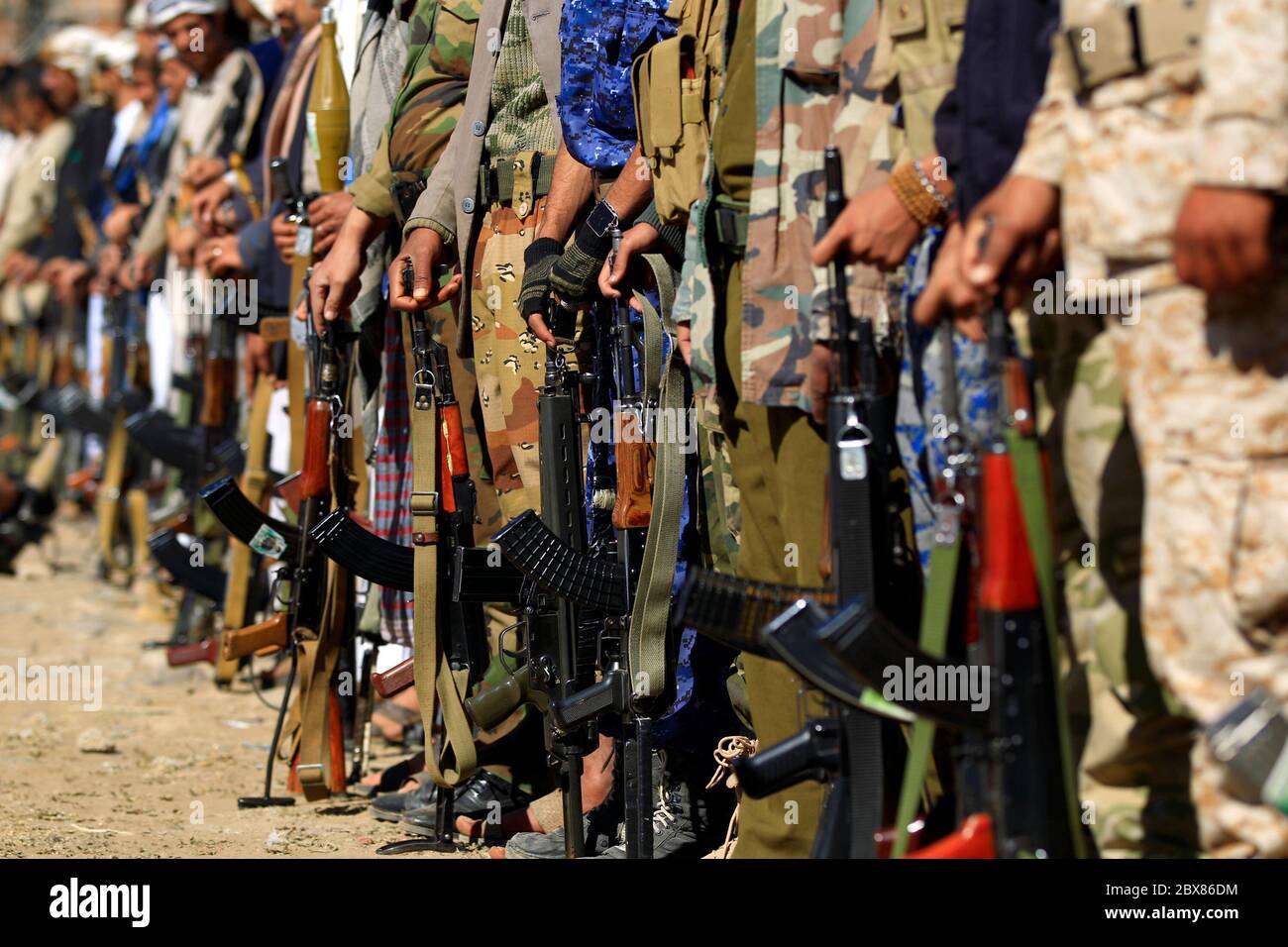 Armed Yemeni men hold their weapons as they gather in the capital Sanaa ...