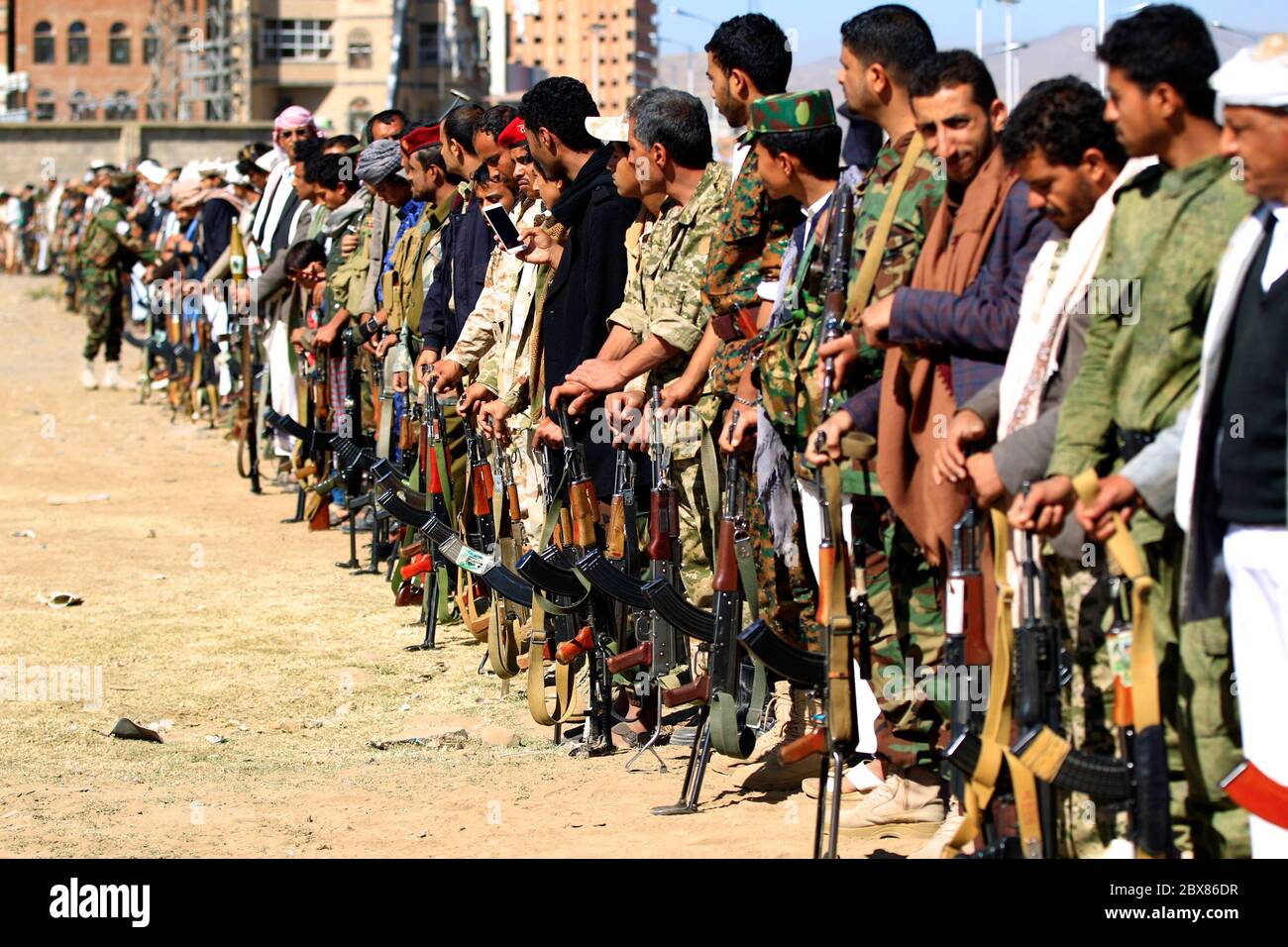 Armed Yemeni men hold their weapons as they gather in the capital Sanaa ...