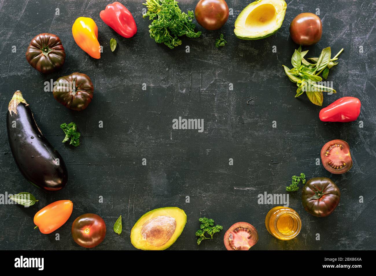 Frame of vegetables and herbs on chalkboard backdrop, healthy vegan ...