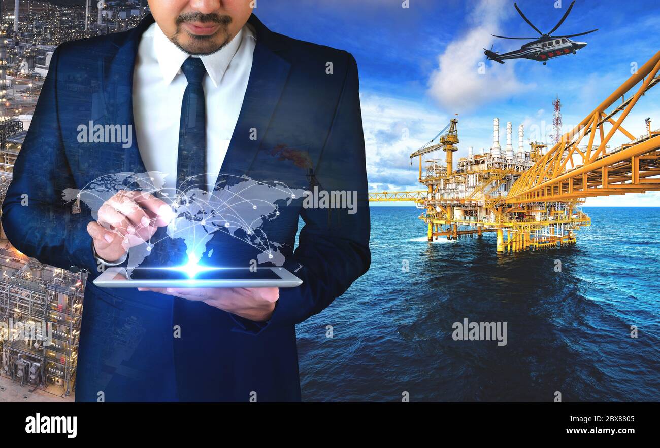 Double exposure of rig and refinery Industry 4.0 - Businessman are ...