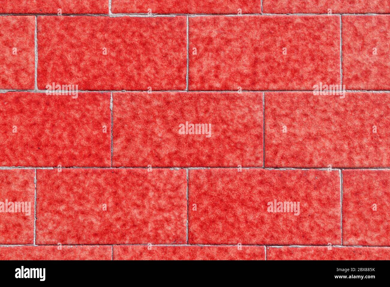 Red brick wall made of symmetrical stone blocks with stains. Natural ...