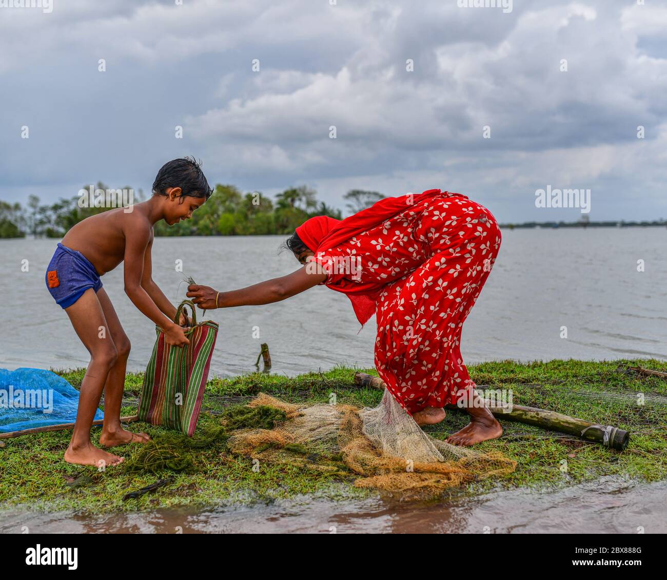 Satkhira, Bangladesh. 05th June, 2020. A woman catching fish with her ...