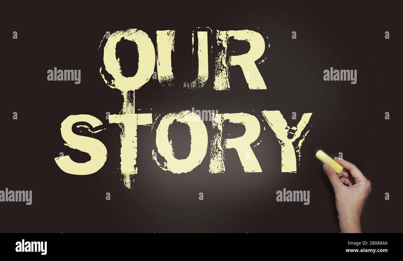 Our story words in pale yellow on blackboard and hand with chalk ...