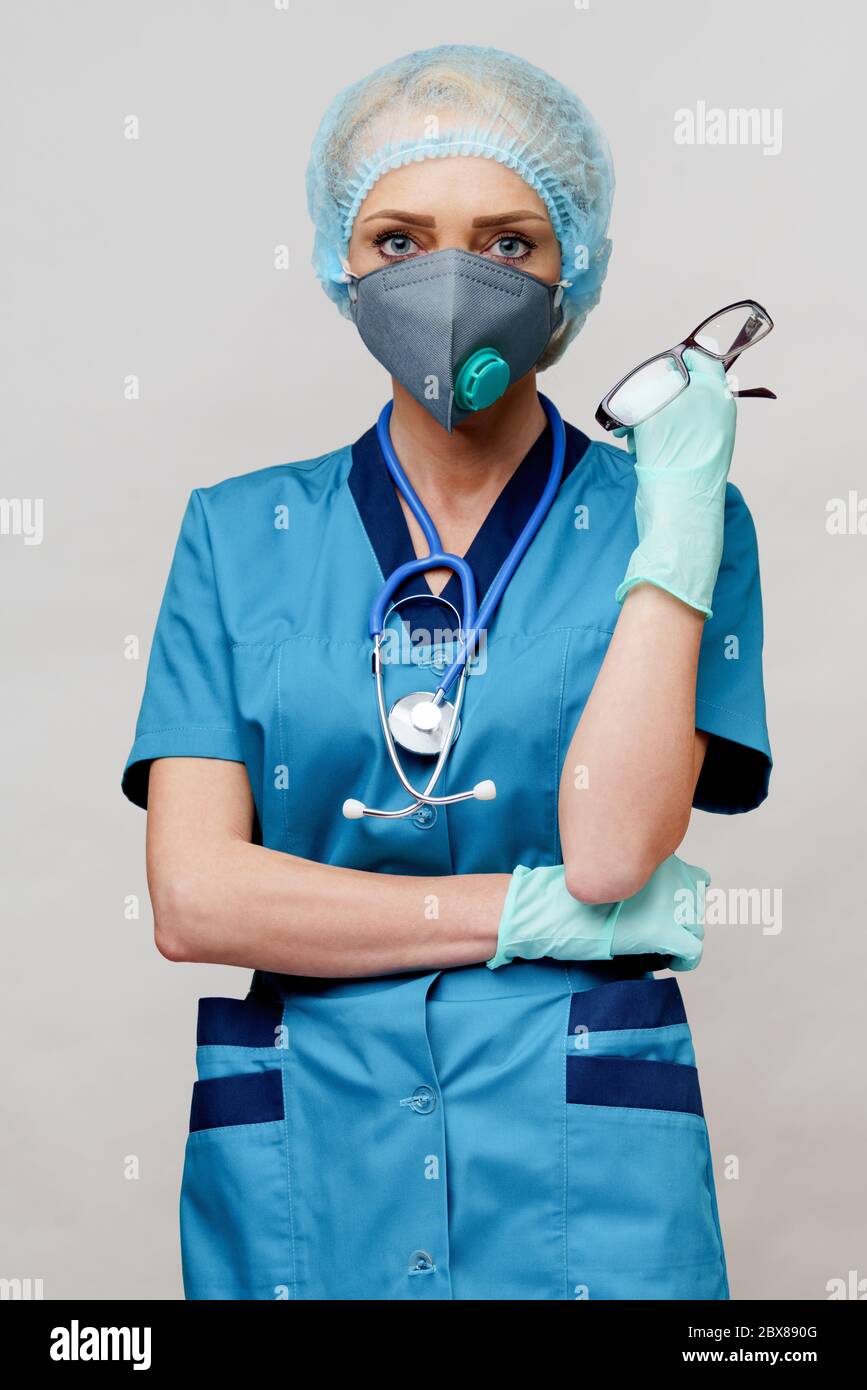 female doctor with stethoscope wearing protective mask and latex gloves ...