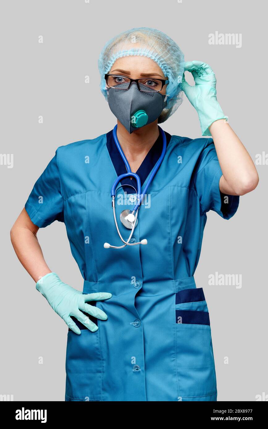female doctor with stethoscope wearing protective mask and latex gloves ...