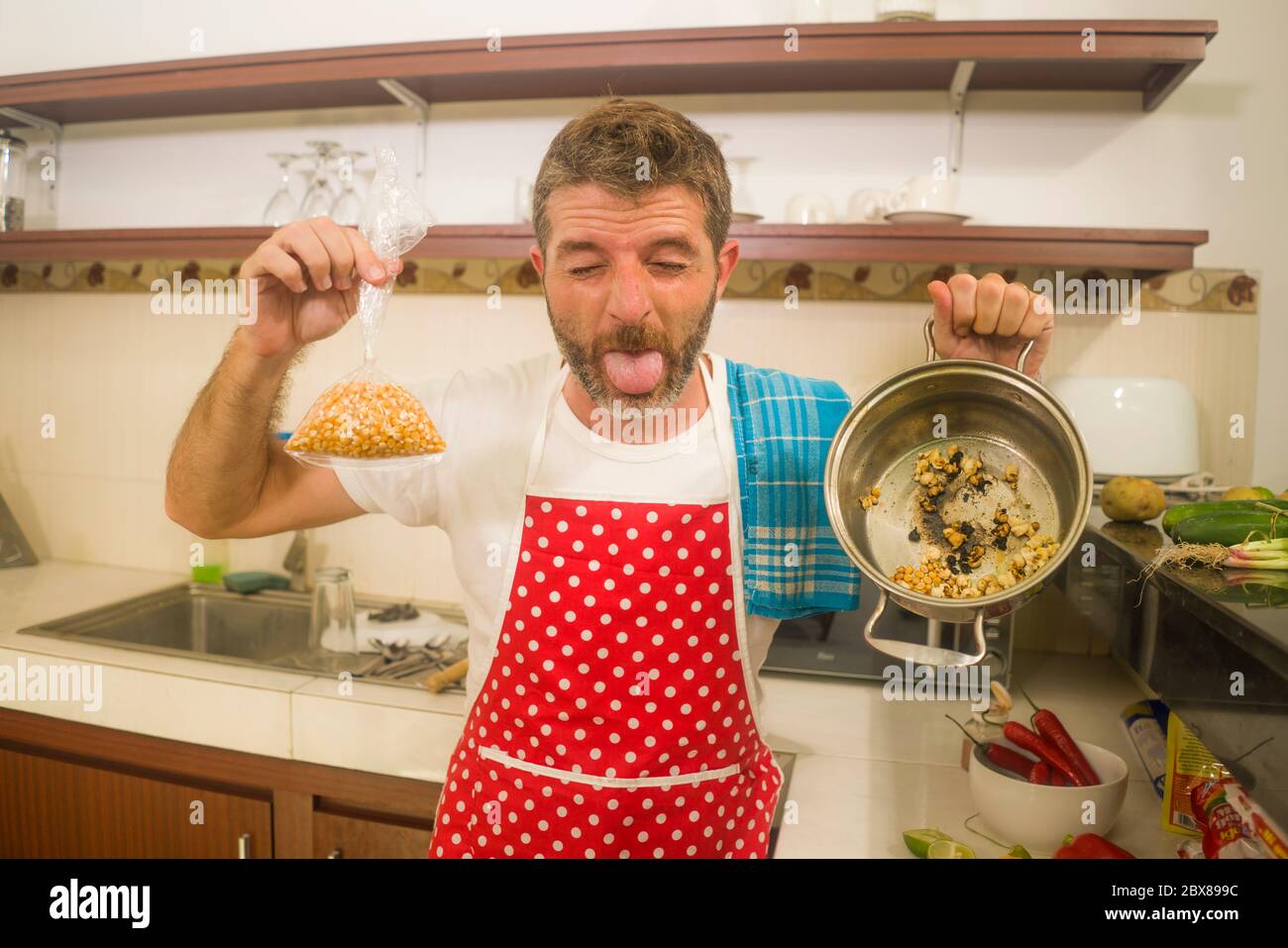 funny domestic portrait of messy and disaster home cook man holding ...