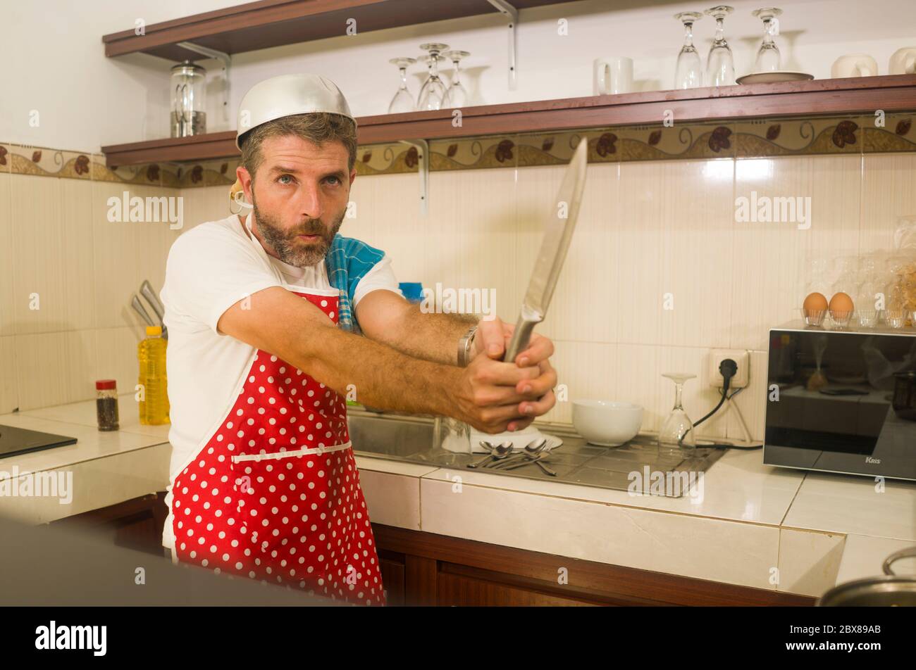 funny domestic portrait of silly and happy home cook man in cooking ...