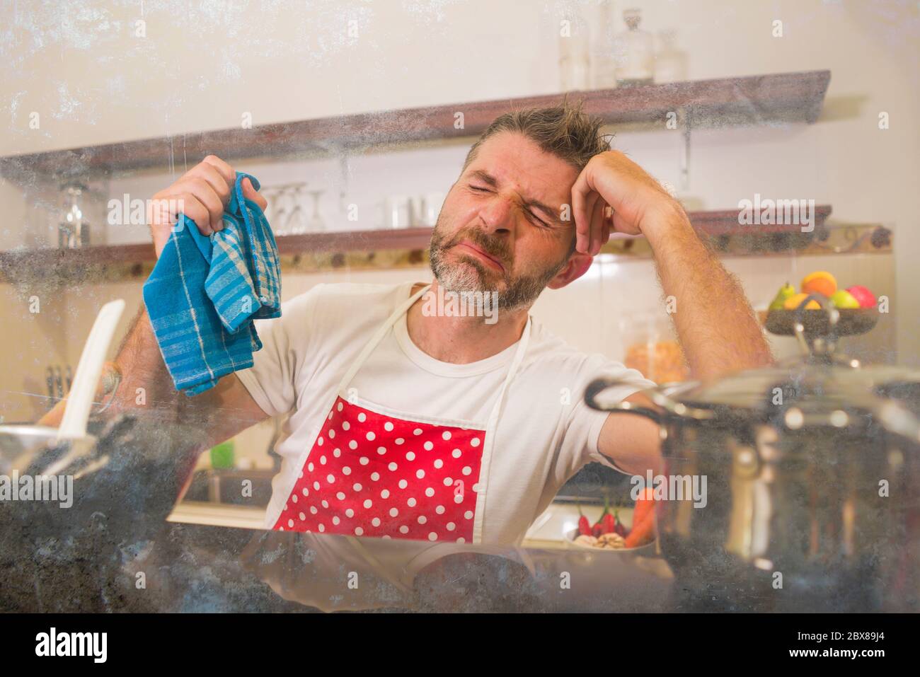 domestic chores stress - young attractive overworked and depressed man ...