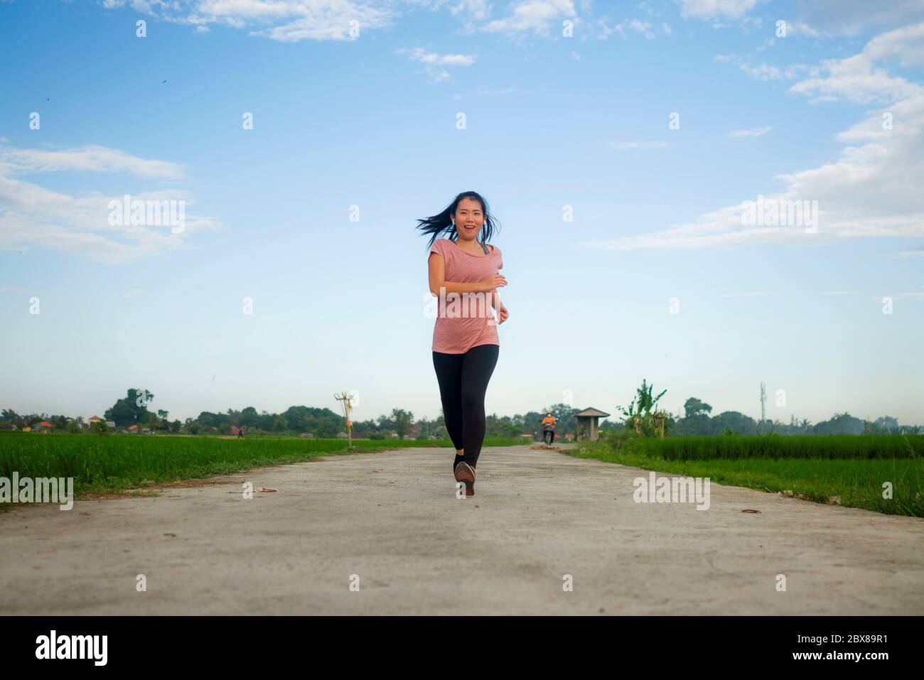 outdoors jogging workout - young happy and dedicated Asian Chinese ...