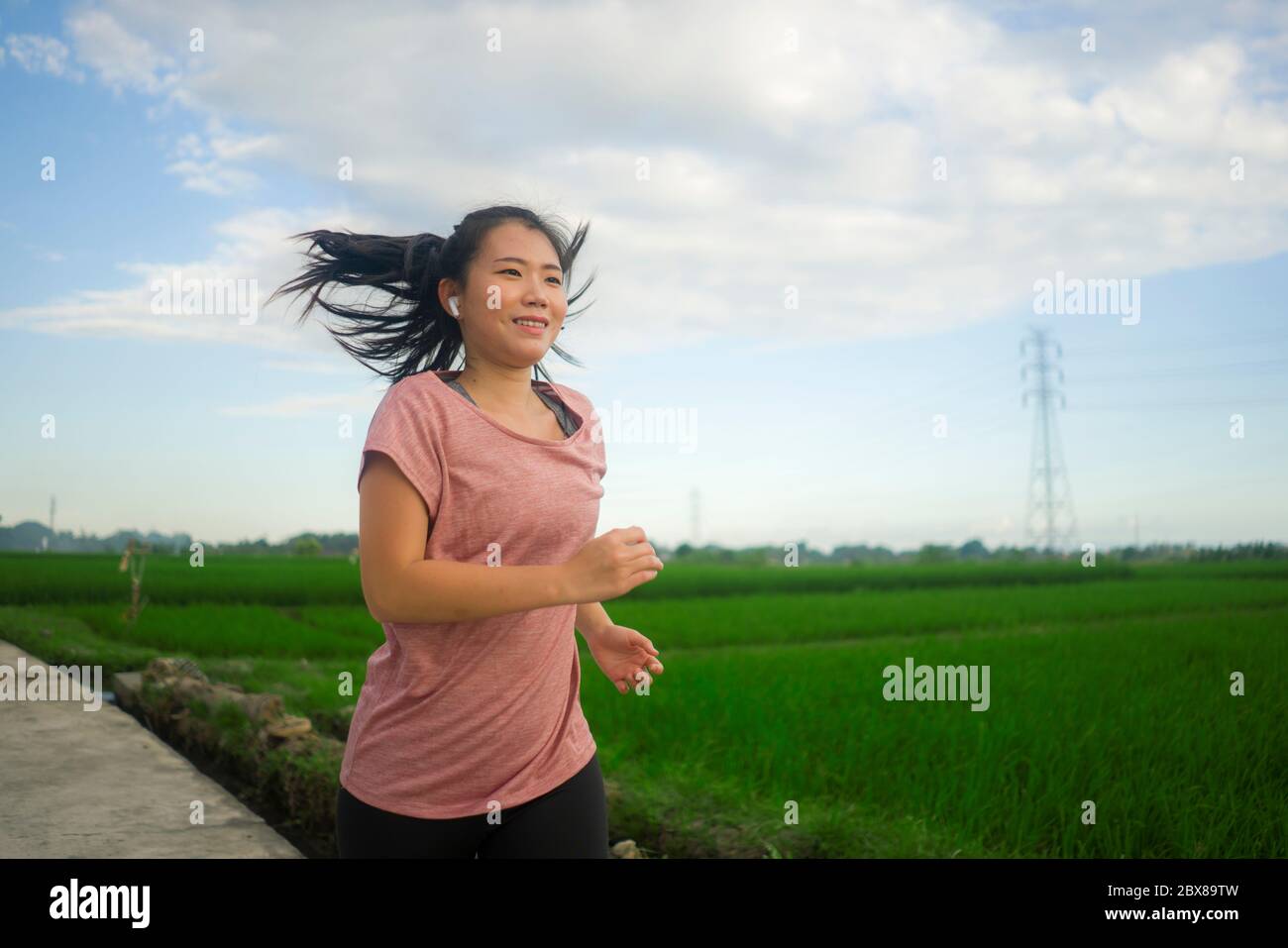 outdoors jogging workout - young happy and dedicated Asian Korean woman ...
