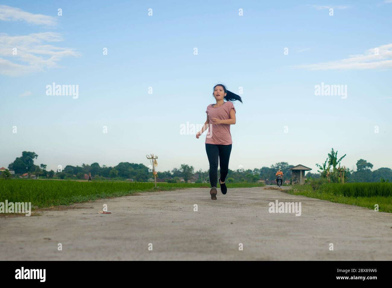 outdoors jogging workout - young happy and dedicated Asian Korean woman ...