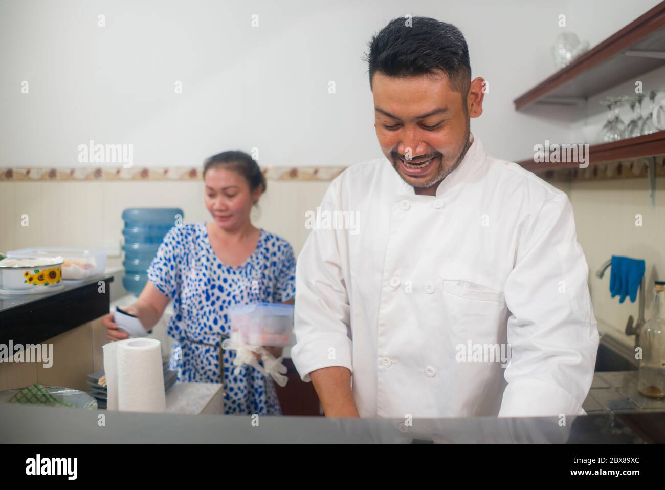happy Asian couple cooking together - home kitchen lifestyle portrait ...