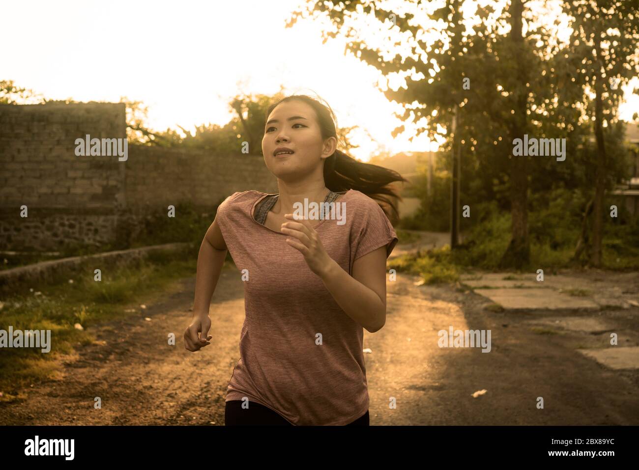 outdoors running - young happy and dedicated Asian Japanese woman ...