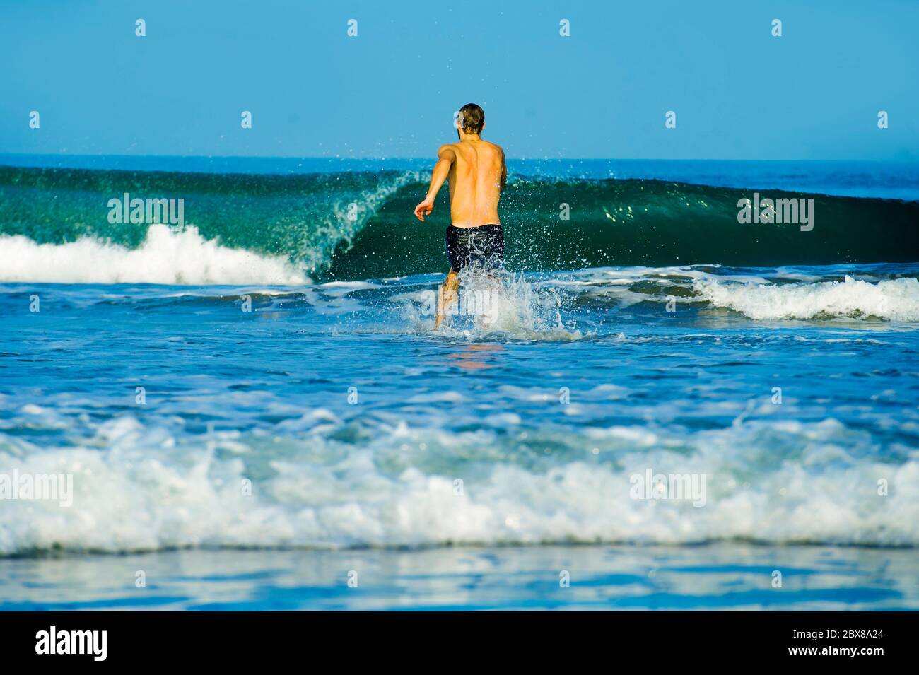 Man Running In Swimming Trunks High Resolution Stock Photography and ...