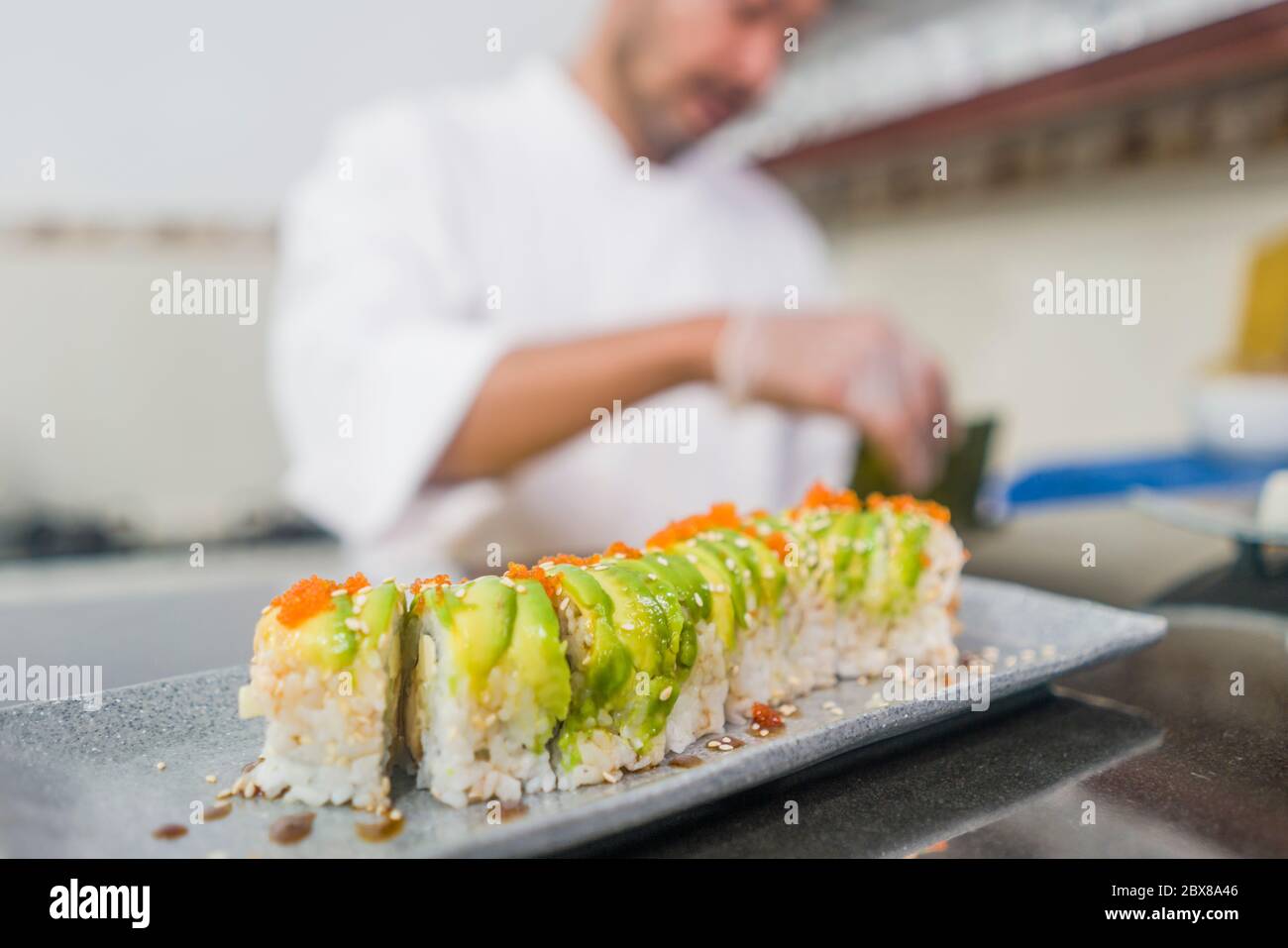 hands in gloves of Asian professional chef preparing delicious and ...