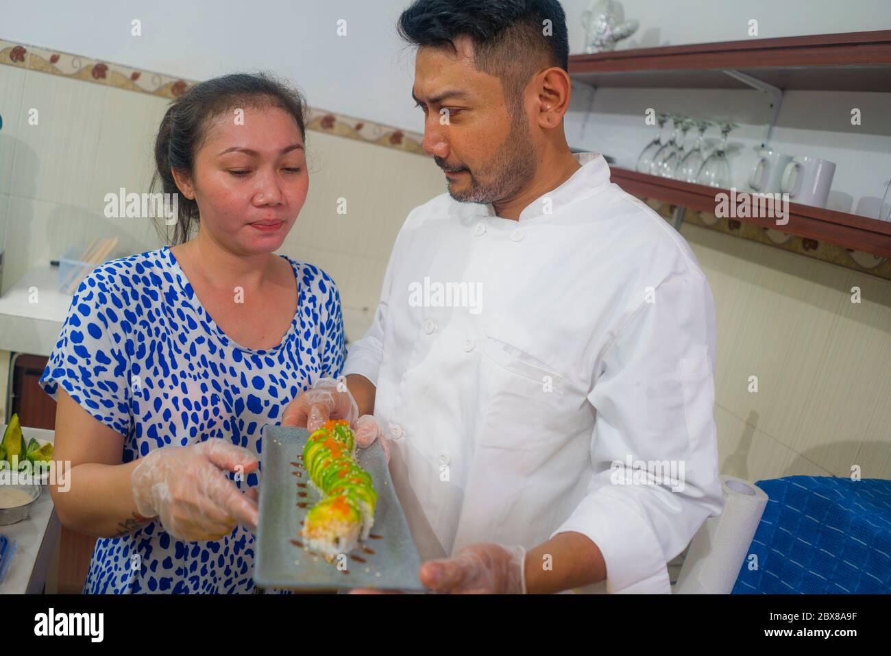 happy Asian couple cooking together - home kitchen lifestyle portrait ...