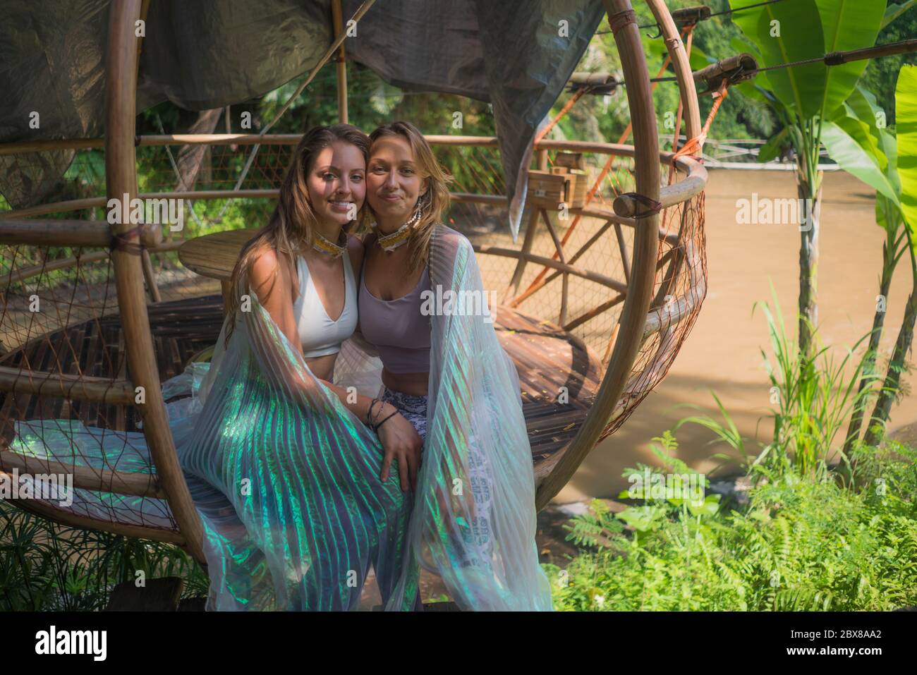 beautiful and happy girlfriends after outdoors yoga workout - two young ...