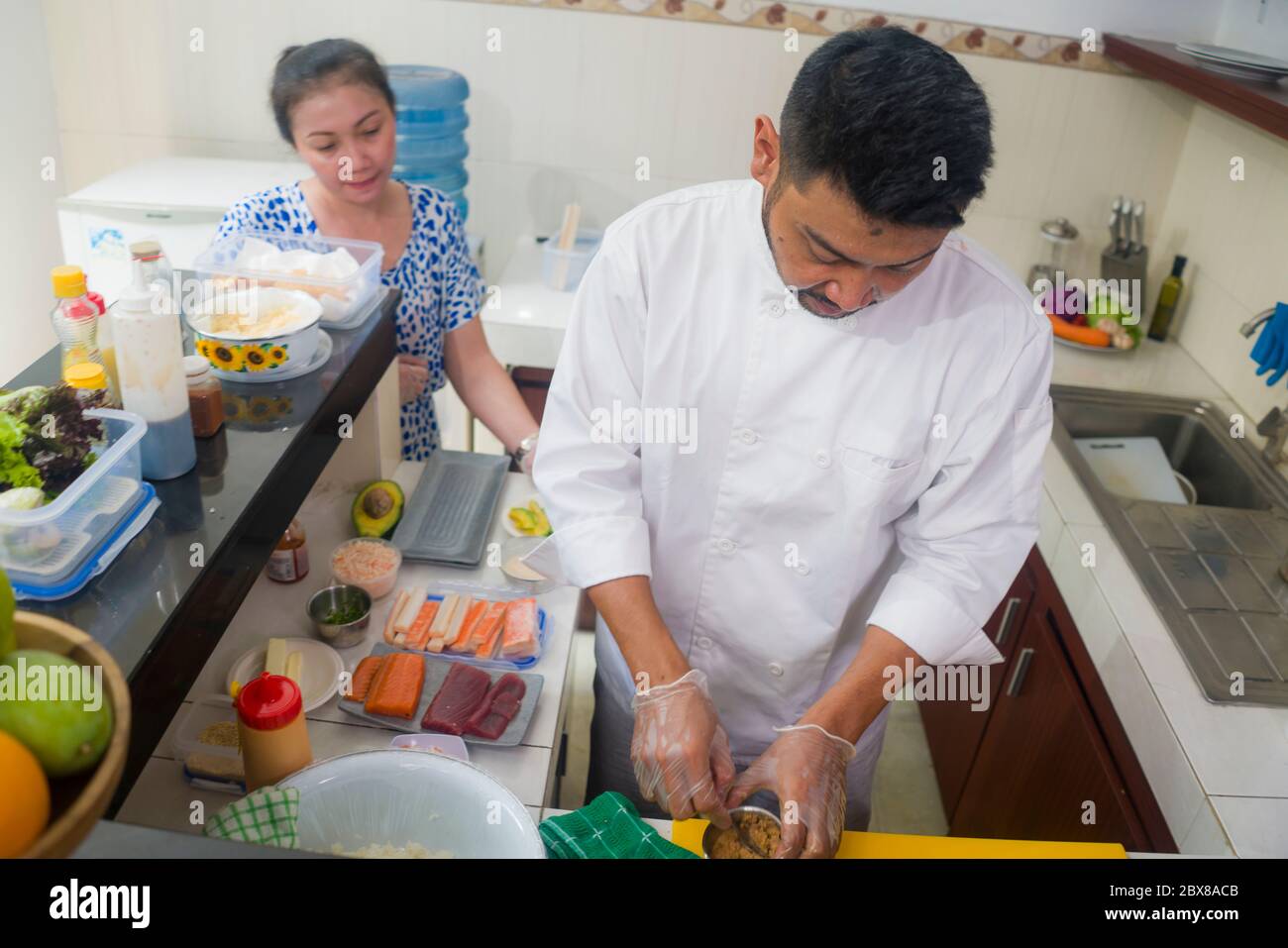 happy Asian couple cooking together - home kitchen lifestyle portrait ...