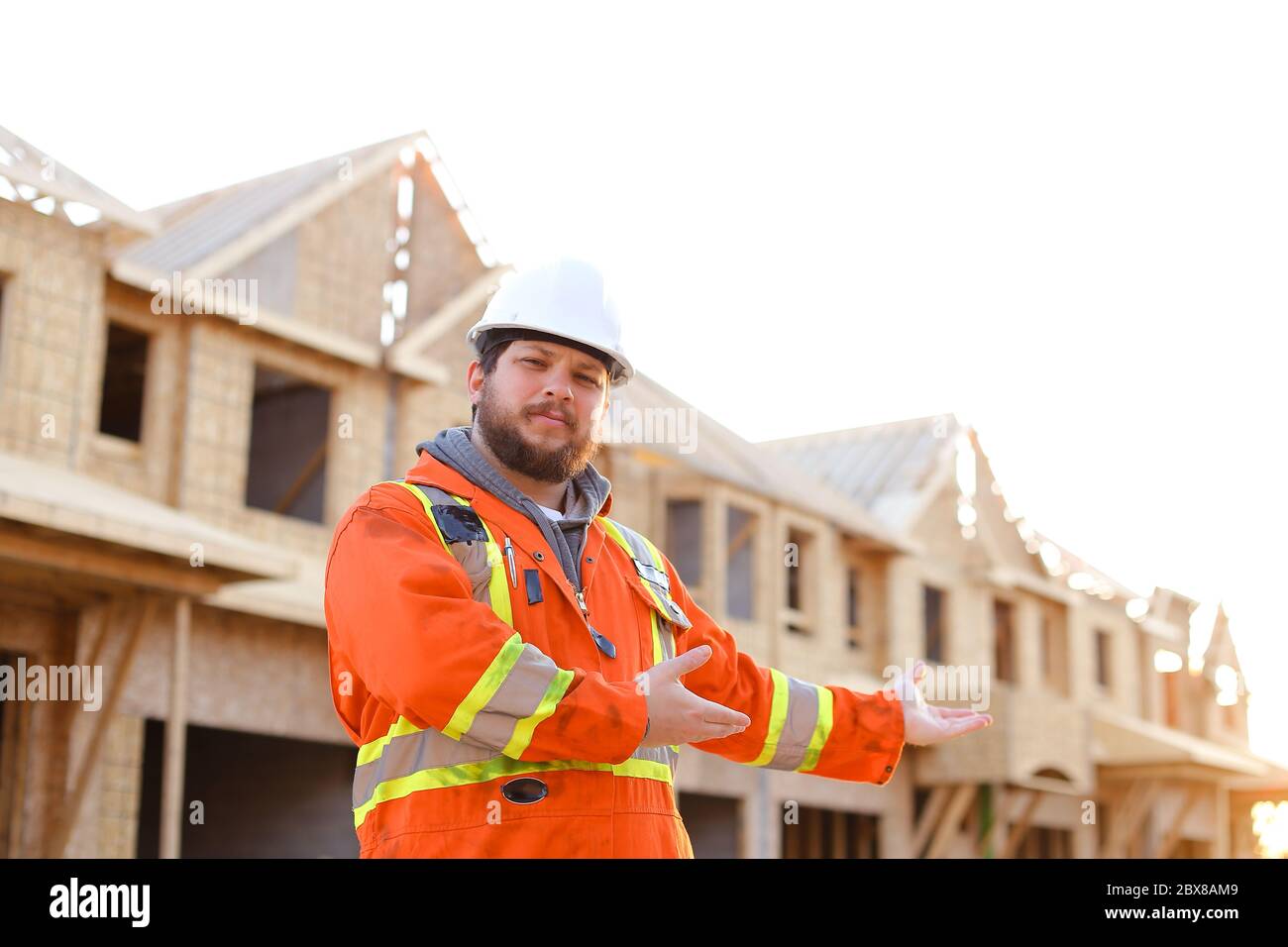 Male foreman showing construction site, building in background Stock ...