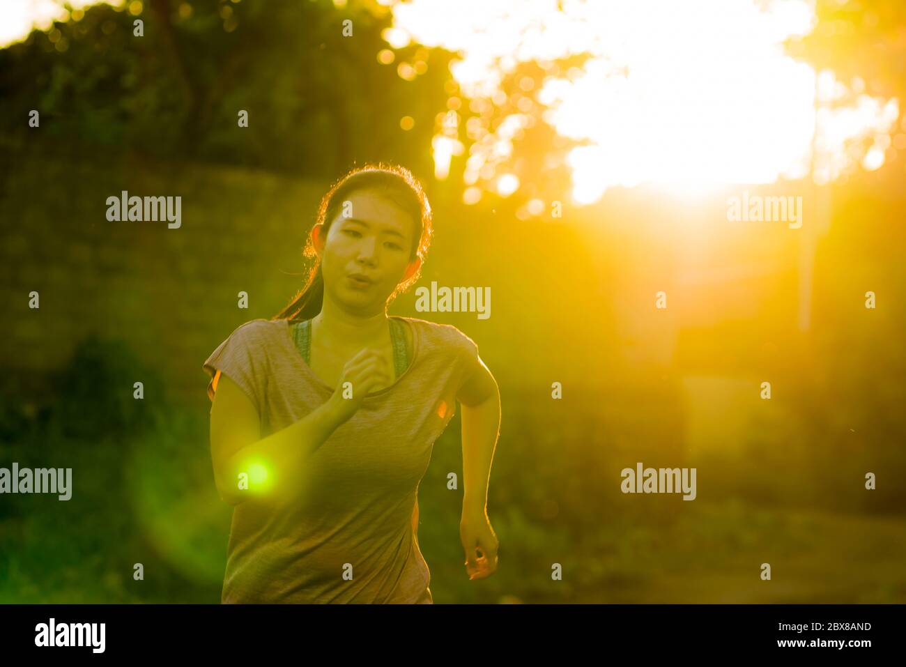 outdoors running workout - young happy and dedicated Asian Korean woman ...