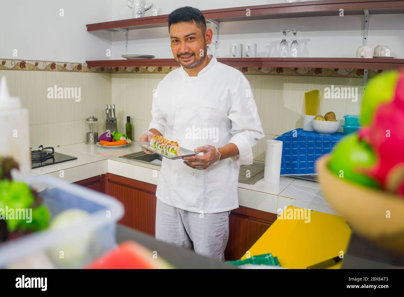 lifestyle portrait of Asian home cook man or professional chef cooking ...