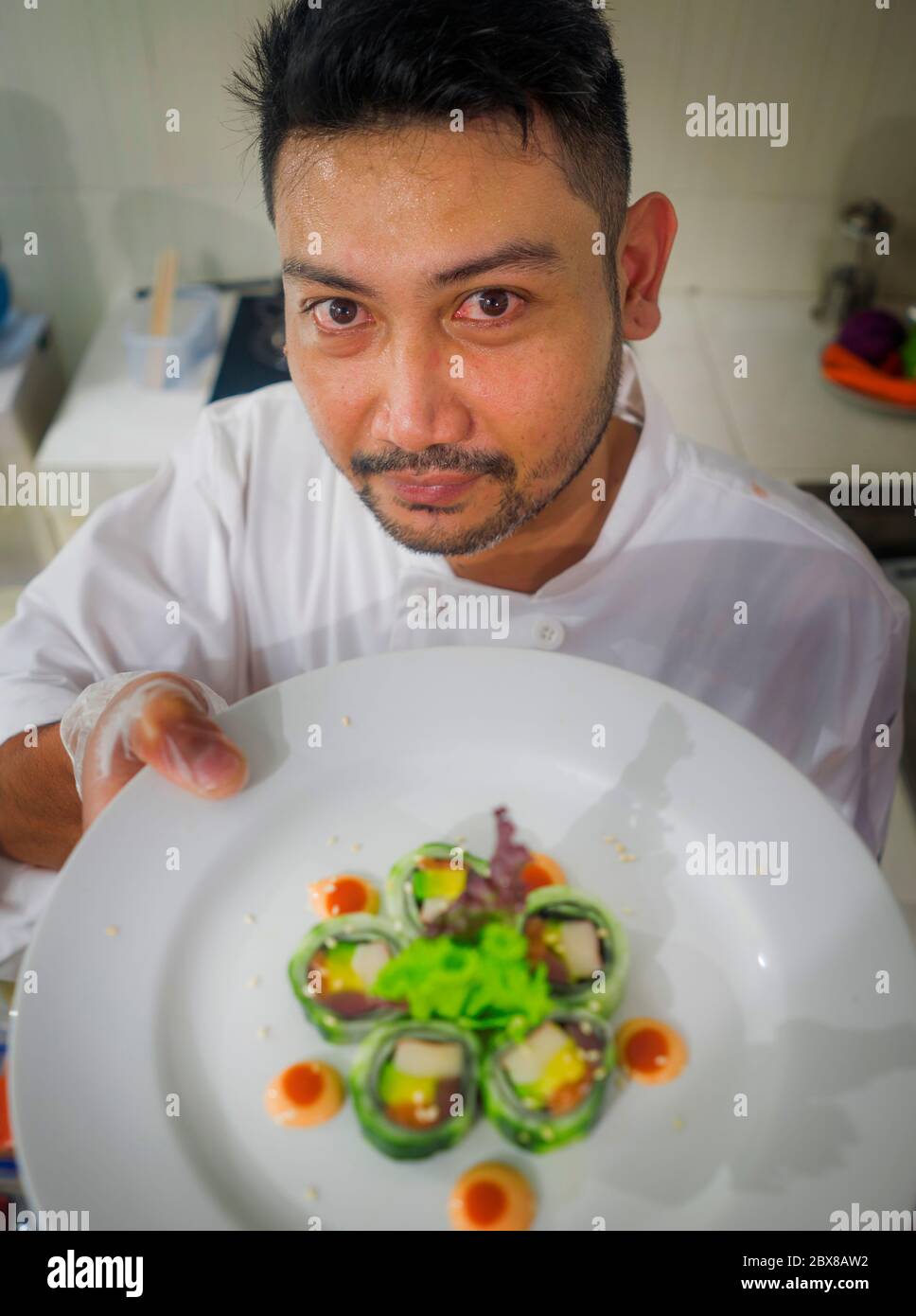 lifestyle portrait of Asian home cook man or professional chef cooking ...