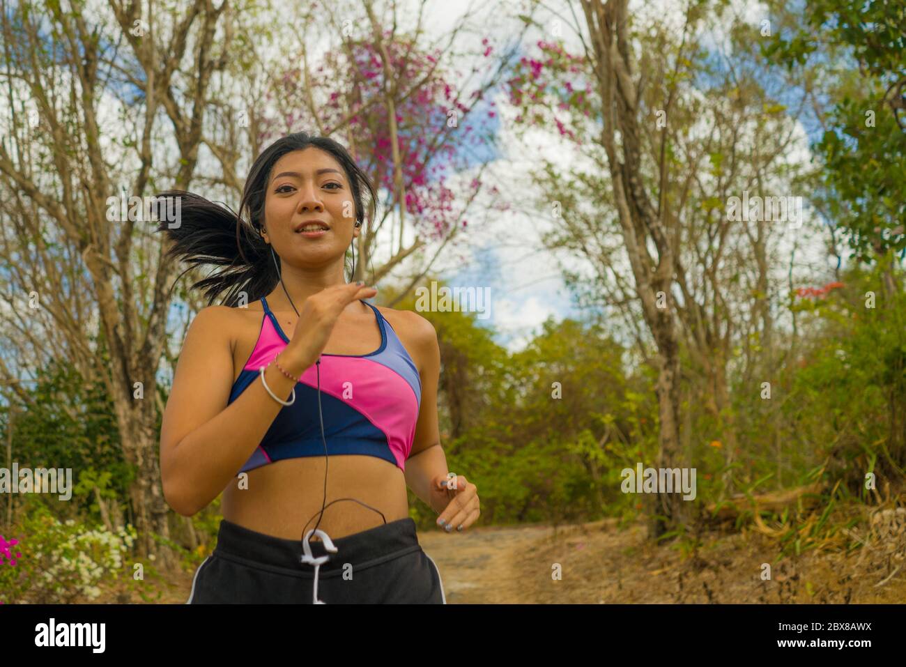 frontal view of young attractive and exotic Asian Indonesian runner ...