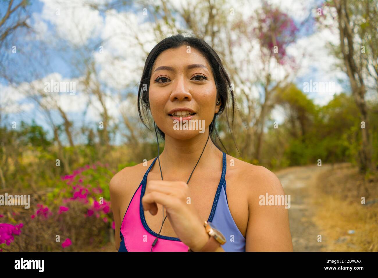 frontal view of young attractive and exotic Asian Indonesian runner ...