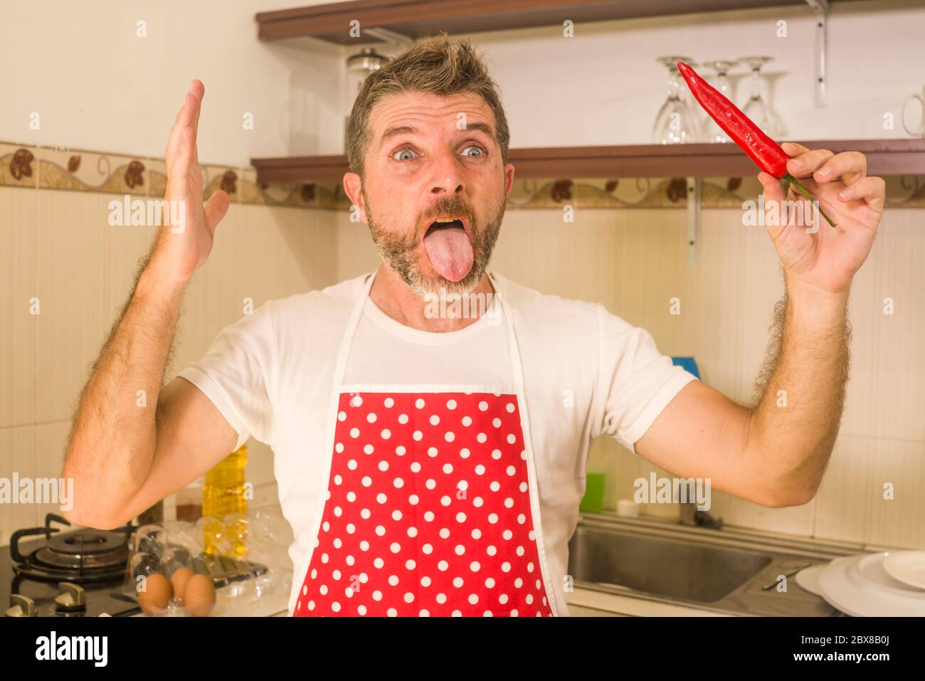 Man eating chilli hi-res stock photography and images - Alamy