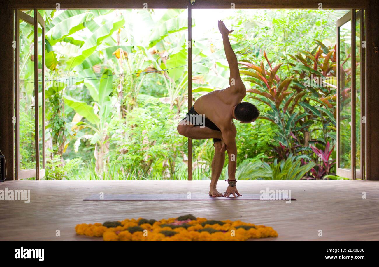natural portrait of young attractive and fit acrobat man practicing ...