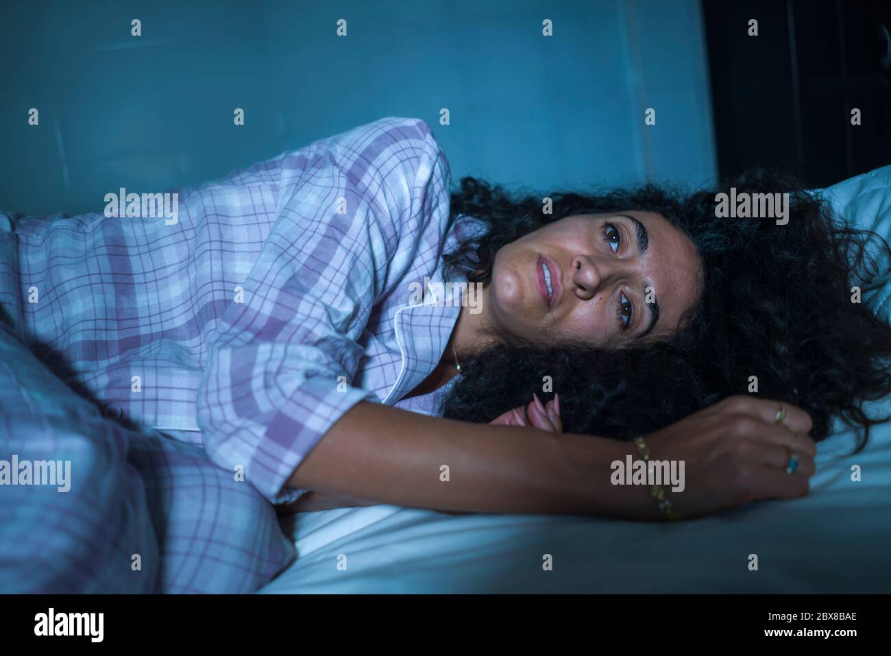 dramatic night lifestyle portrait of young sad and depressed latin ...