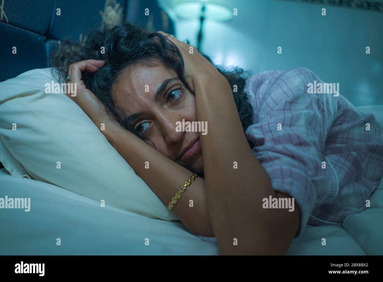 dramatic night lifestyle potrait of young sad and depressed middle ...