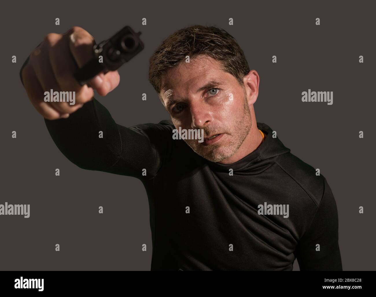 action portrait of angry and attractive hitman or special agent man ...