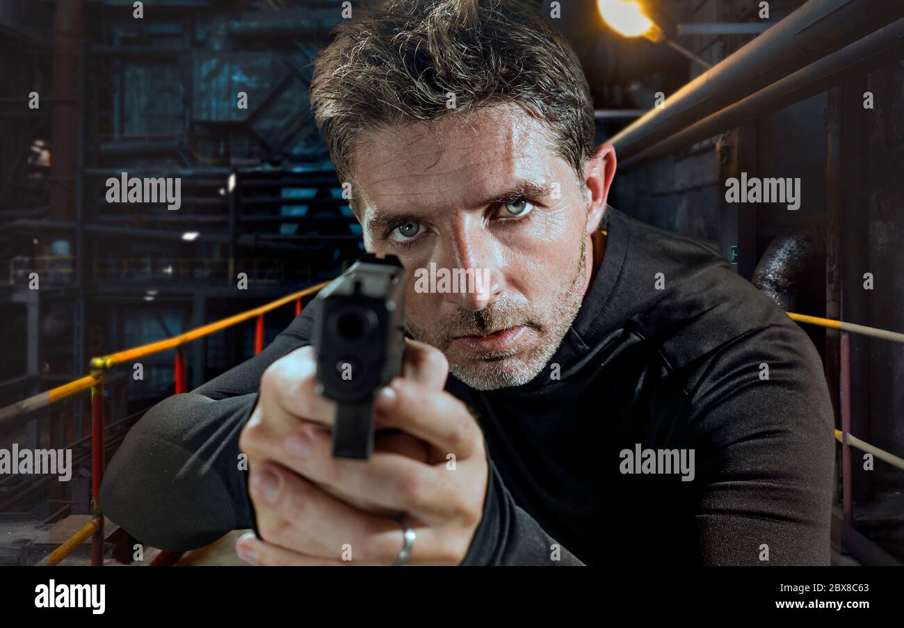 action portrait of serious and attractive hitman or special agent man ...