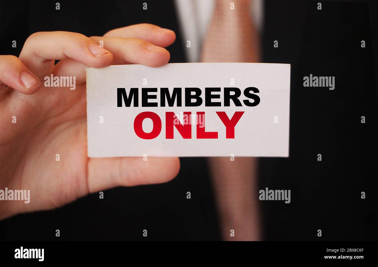 MEMBERS ONLY on a card Businessman holds. VIP clients in business ...