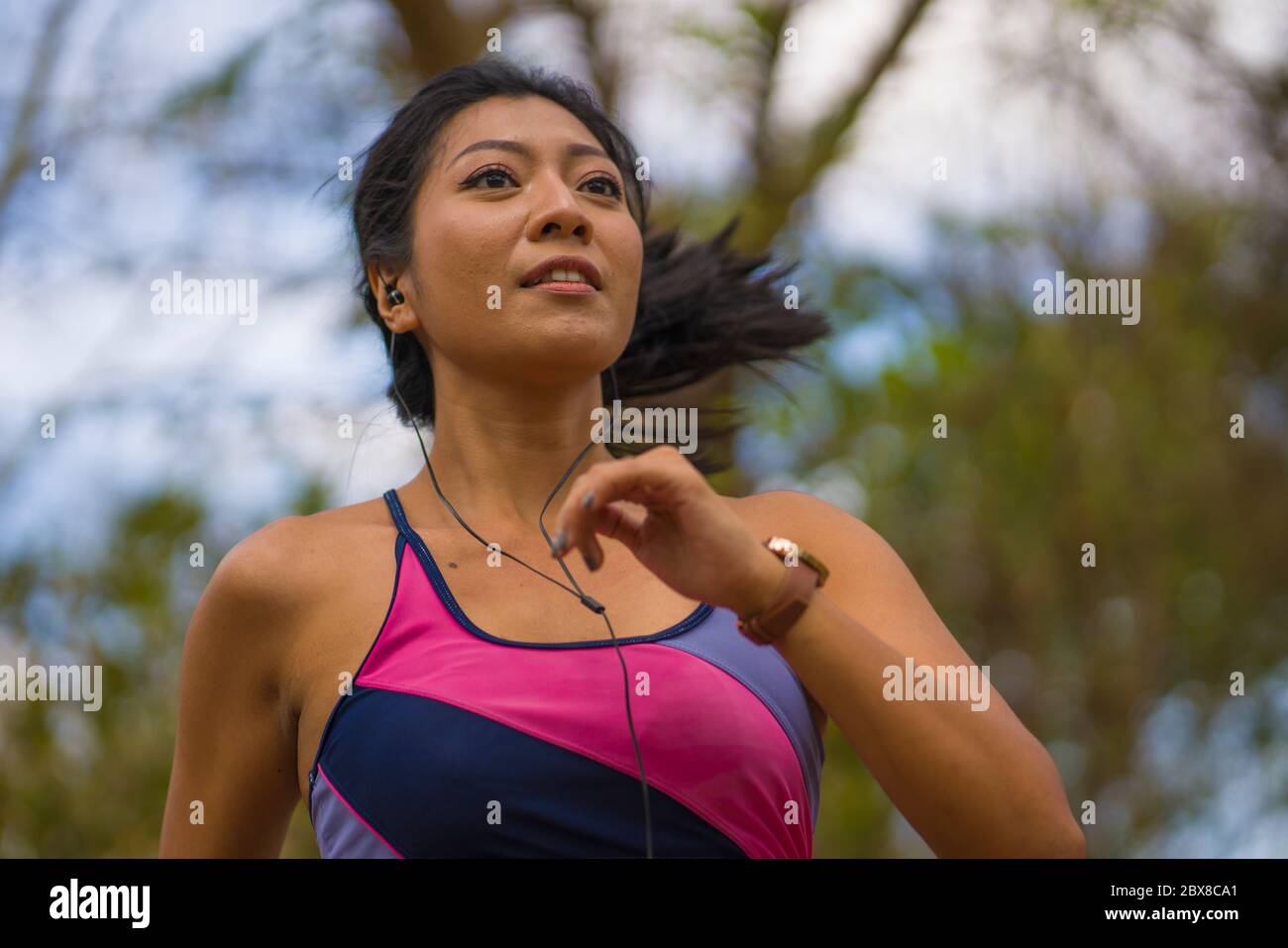 young happy attractive and exotic Asian Indonesian runner woman in ...