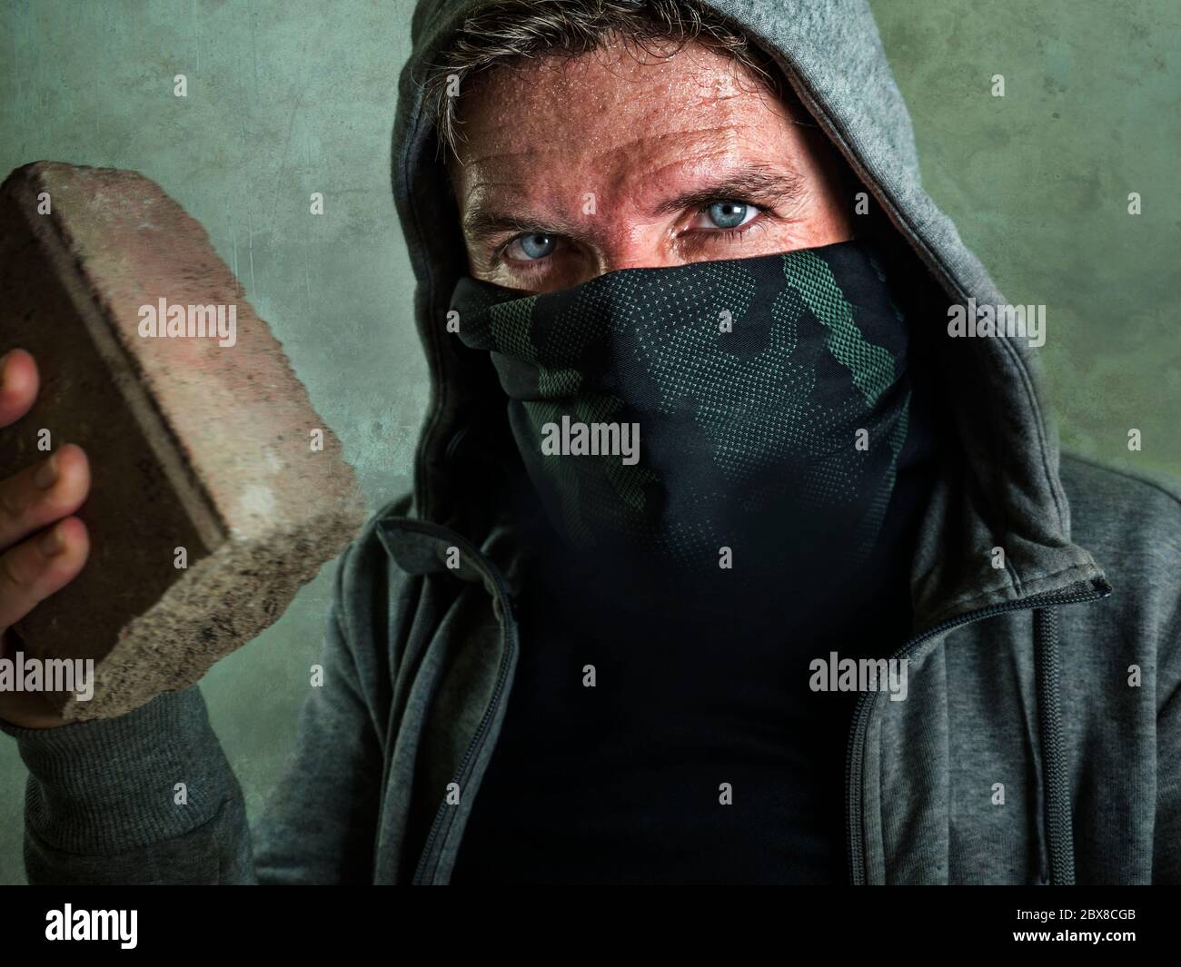 Rioter throwing brick hi-res stock photography and images - Alamy