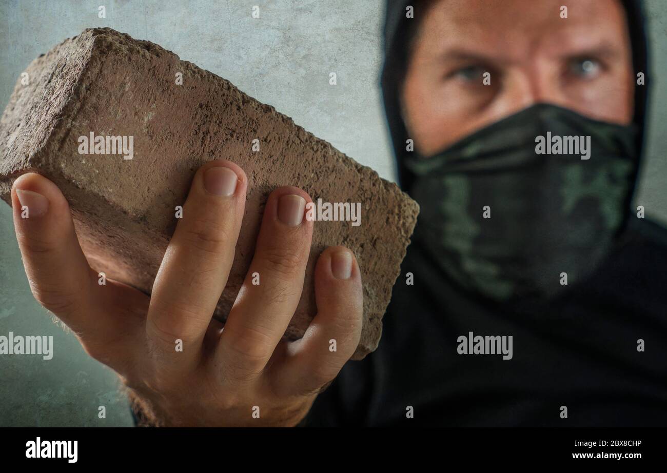 Rioter throwing brick hi-res stock photography and images - Alamy