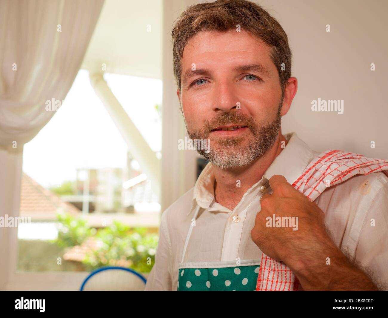 Cheerful husband doing household chores hi-res stock photography and ...