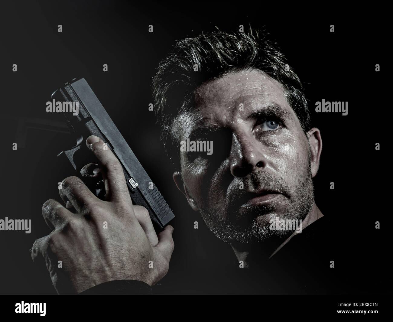 closeup portrait of serious and attractive hitman or special agent man ...