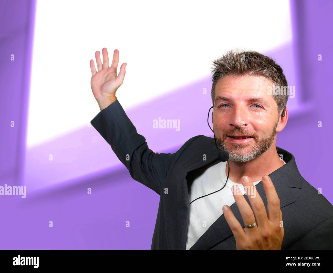 young attractive and confident successful man with headset speaking at ...