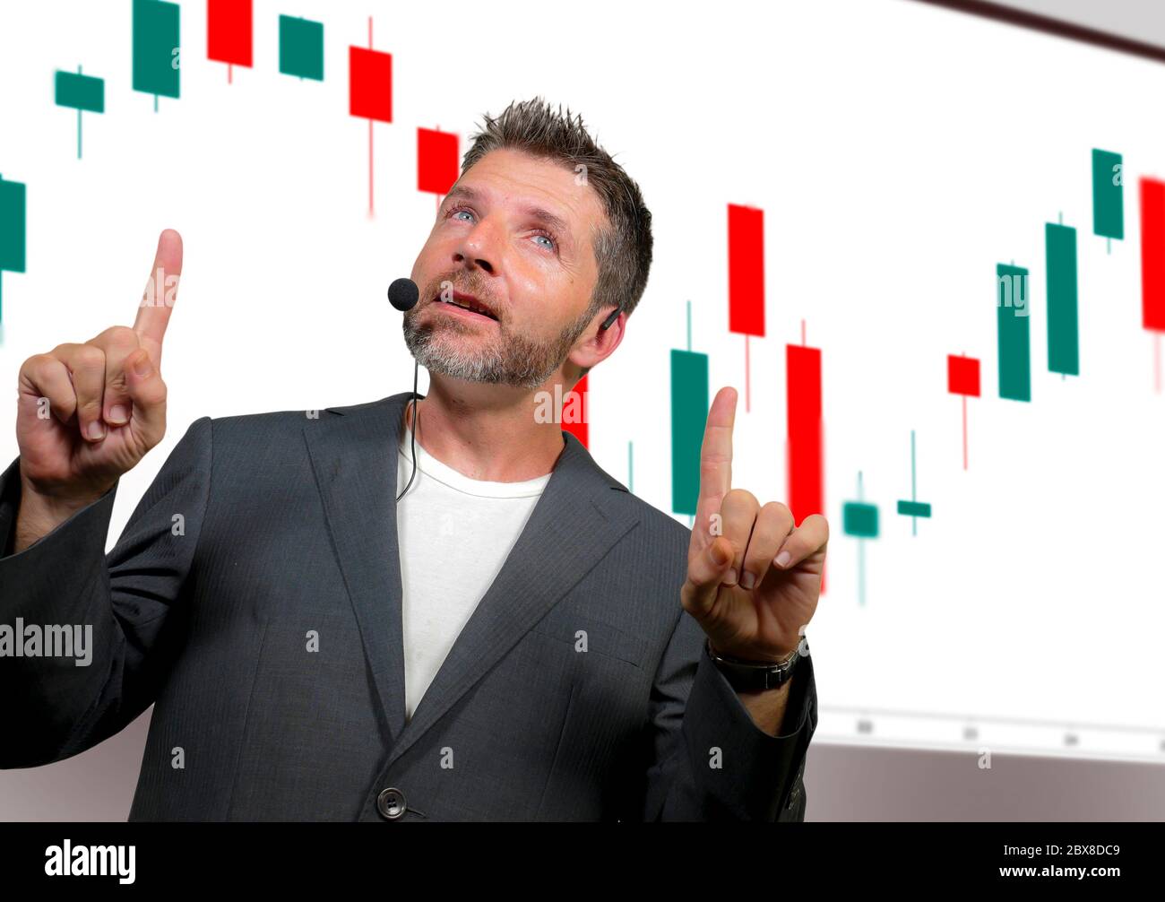 attractive and confident successful trader man with headset speaking at ...